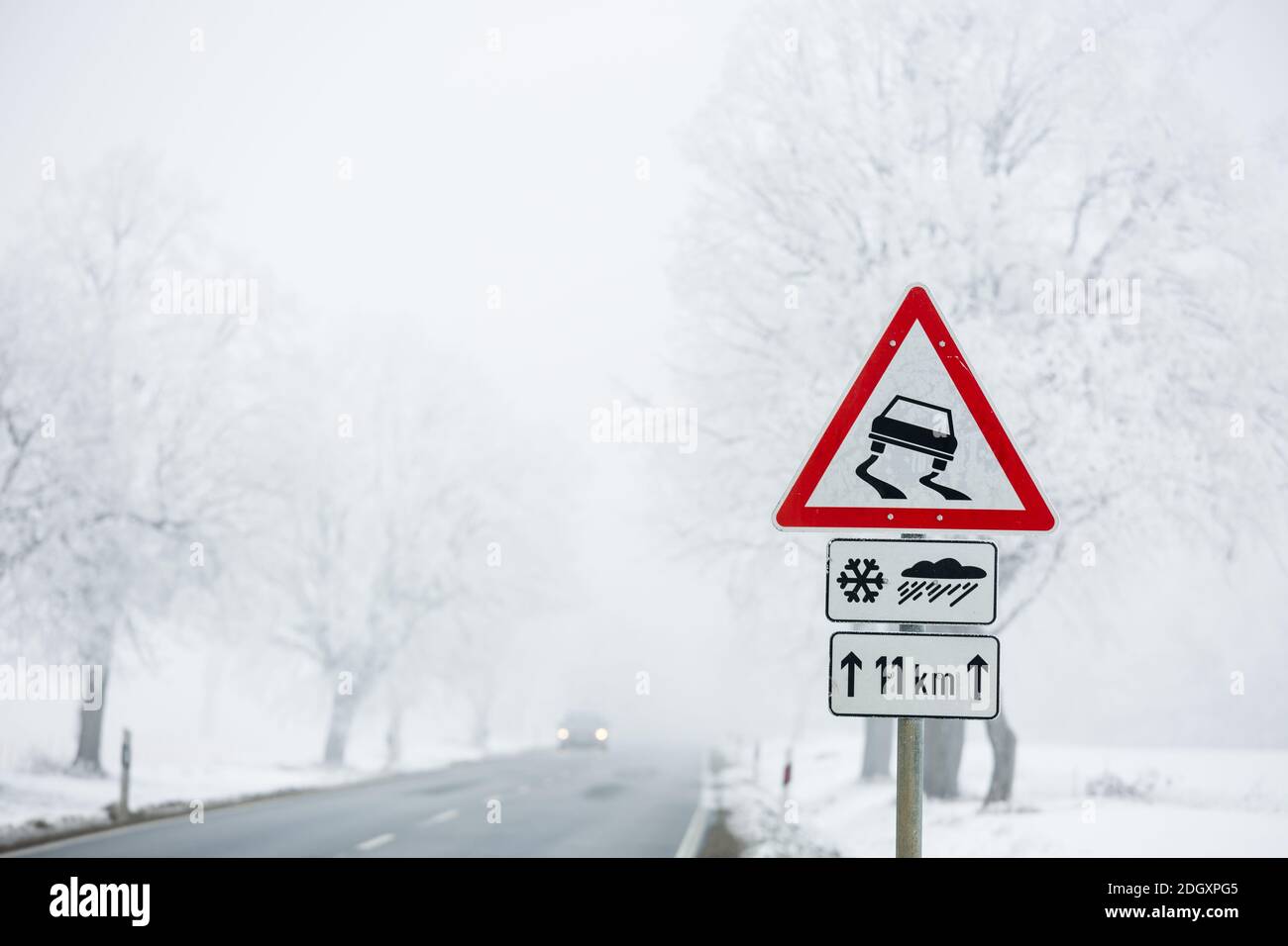 winter warning sign with snow Stock Photo - Alamy
