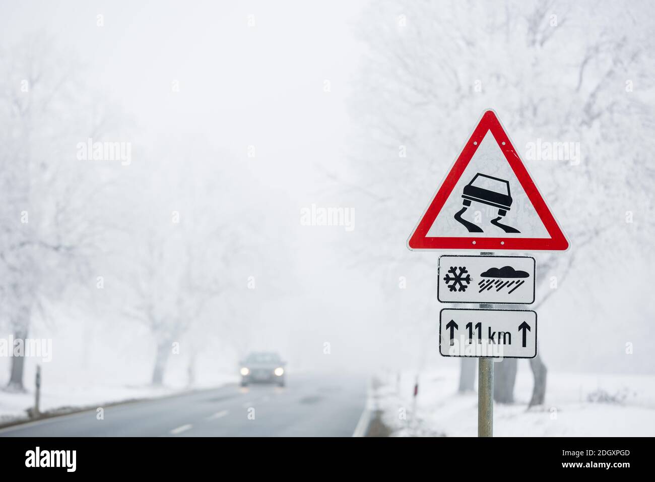 winter warning sign with snow Stock Photo - Alamy