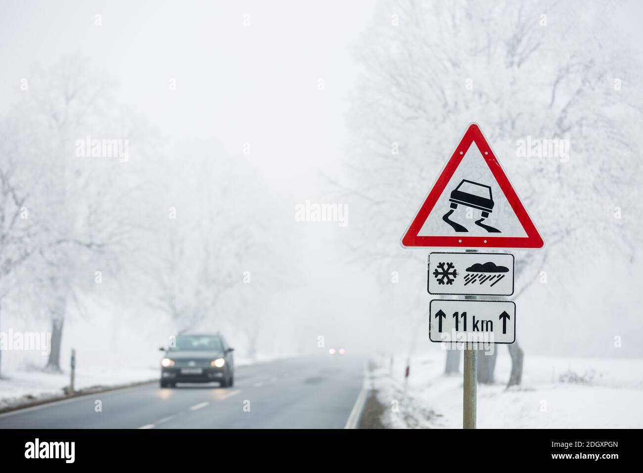 winter warning sign with snow Stock Photo - Alamy