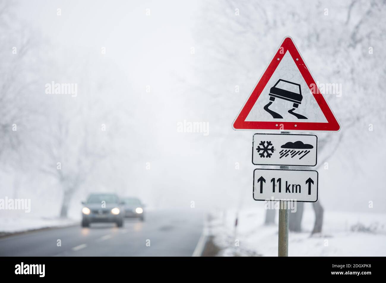 winter warning sign with snow Stock Photo - Alamy