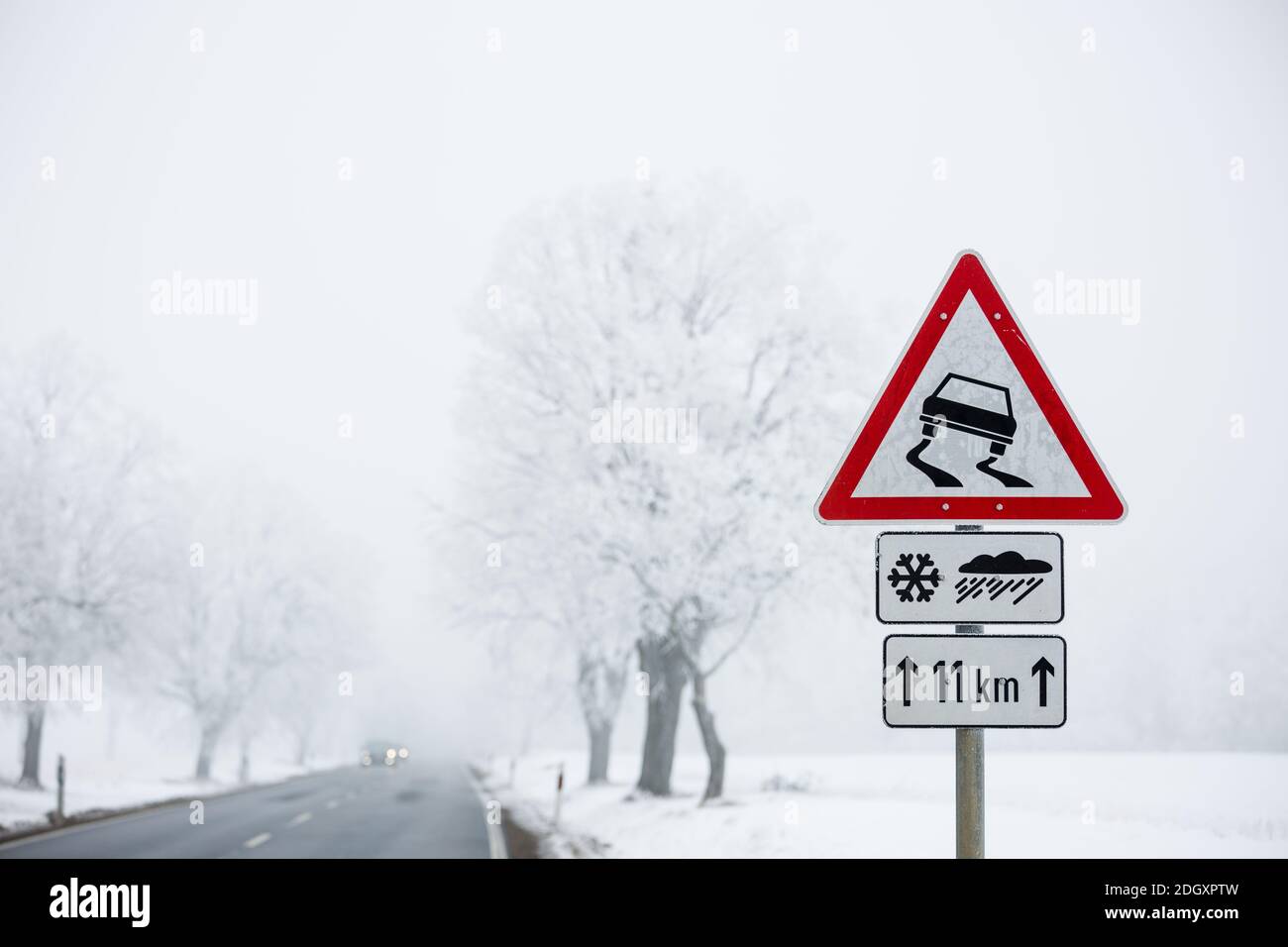 winter warning sign with snow Stock Photo - Alamy