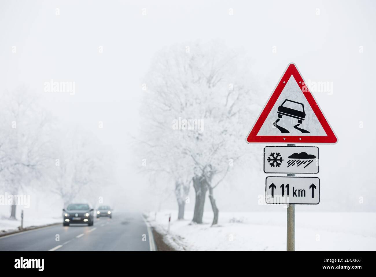 winter warning sign with snow Stock Photo - Alamy