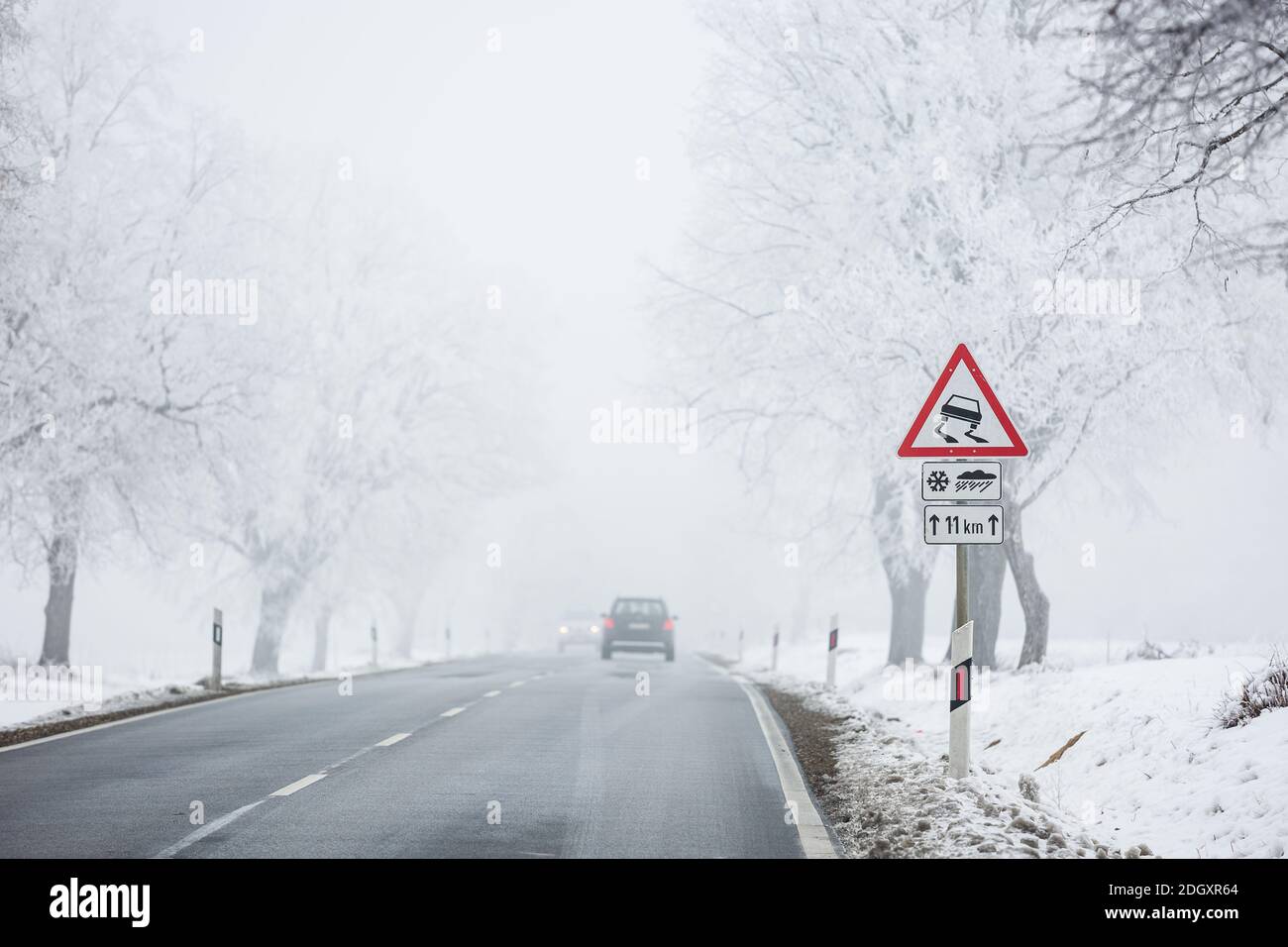 winter warning sign with snow Stock Photo - Alamy