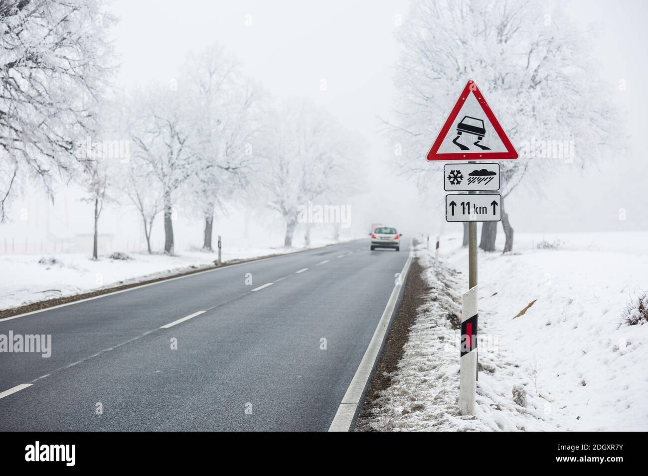 winter warning sign with snow Stock Photo - Alamy