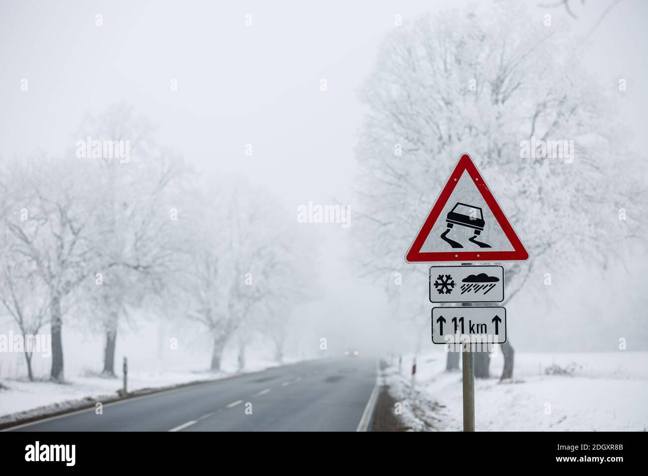 winter warning sign with snow Stock Photo - Alamy