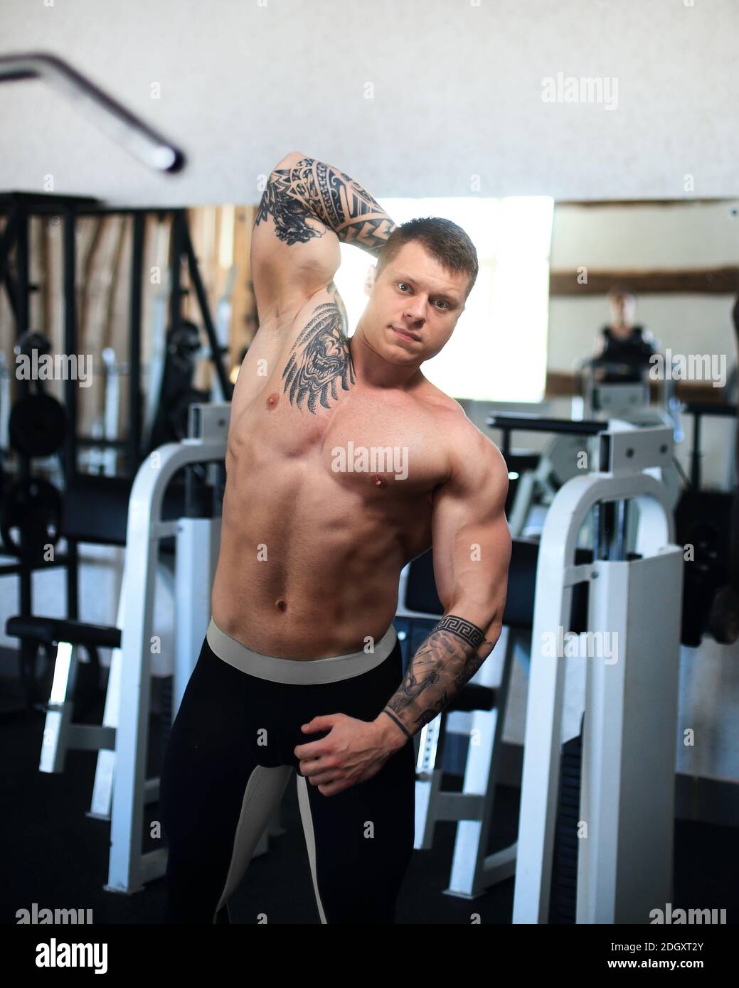 side view. young bodybuilder in the gym Stock Photo - Alamy