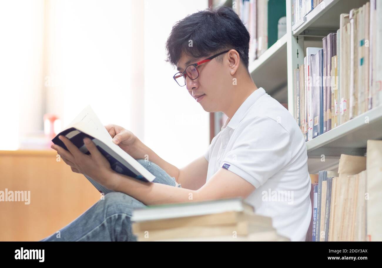 Asian boy reading floor hi-res stock photography and images - Alamy