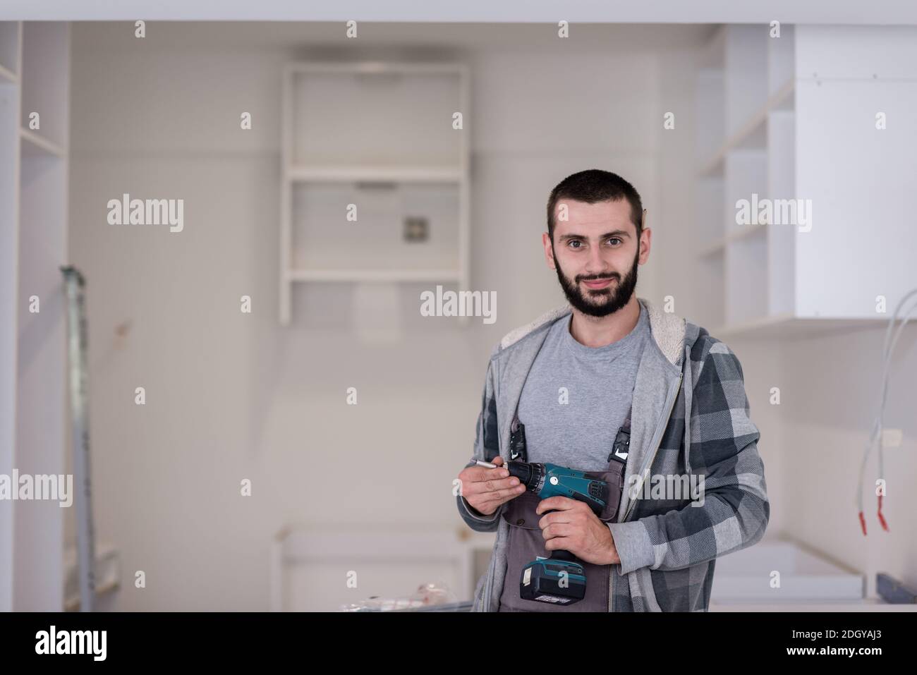 The worker holding a hand drilling machine Stock Photo - Alamy