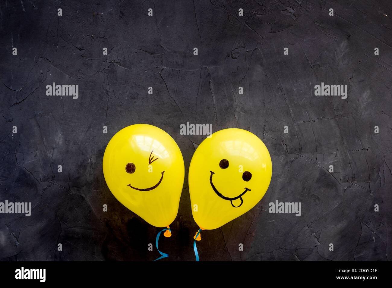 Positive emotions set. Happy and winking emoticons painted on colored ...