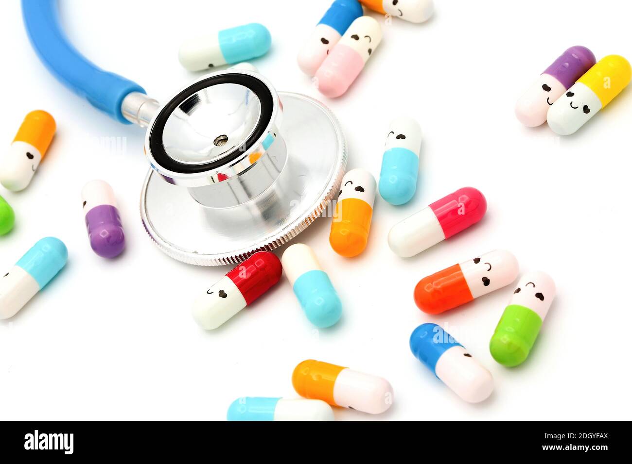 Closeup on medical capsules and pills with happy smiling faces on white ...
