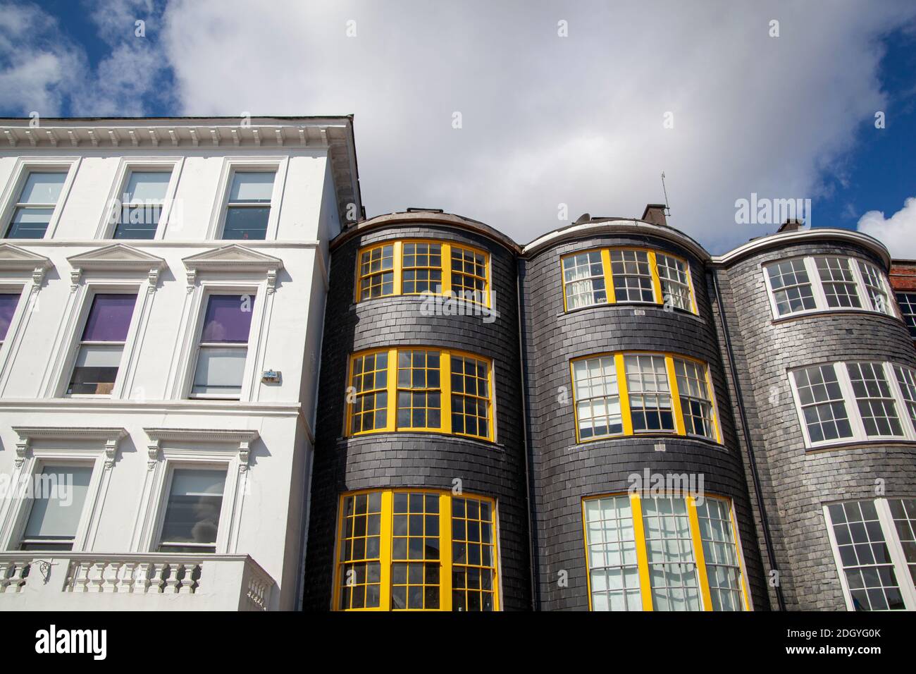 A black facade with yellow windows Stock Photo - Alamy