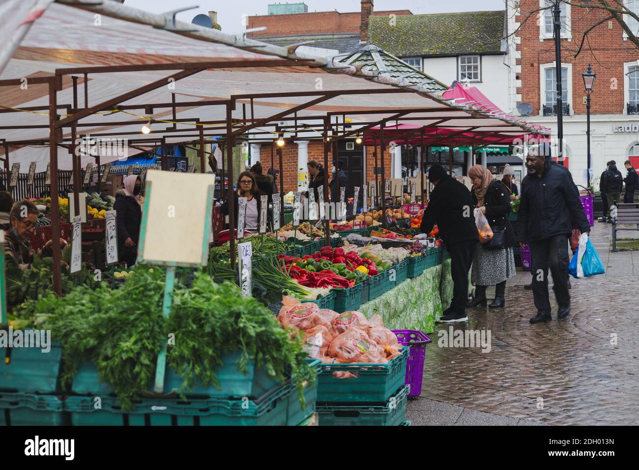 People shopping at fruit and vegetable stall in Bedford Market ...