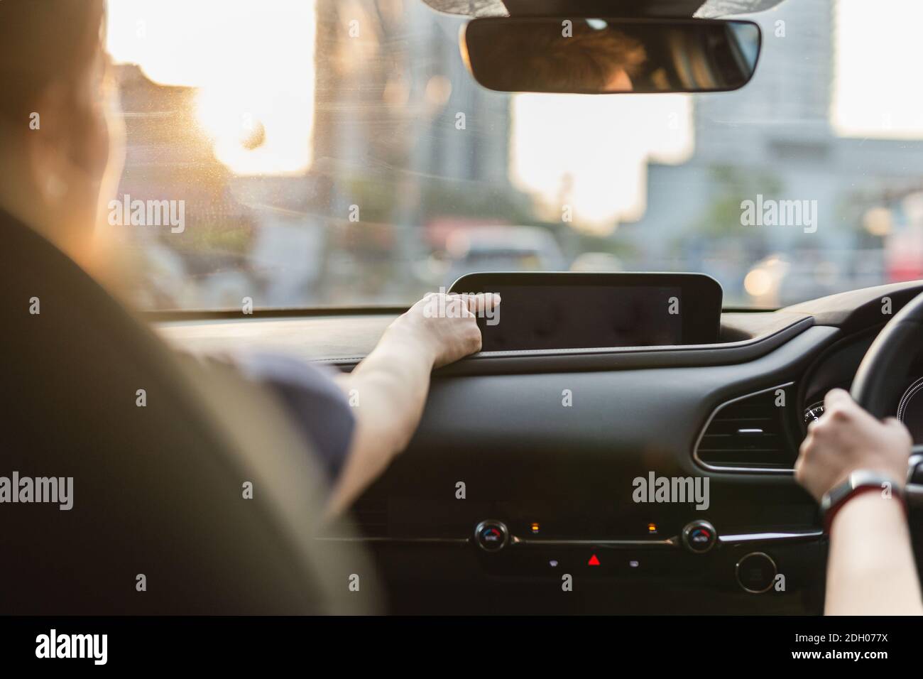 Woman hand touching screen in car while her friend is driving Stock ...
