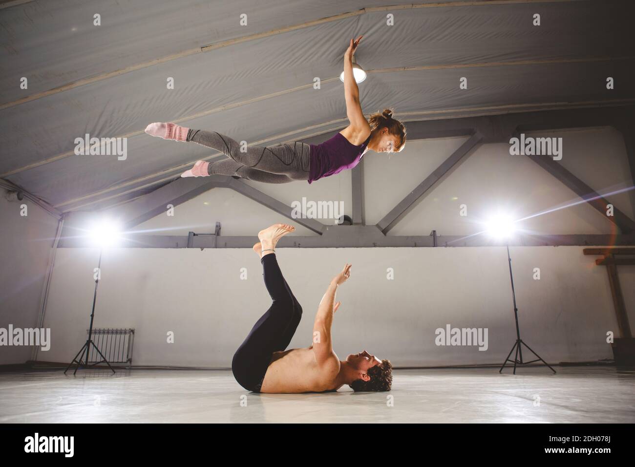 The theme of Acroyoga and Yoga Poses. Acroyogis practicing. with studio ...