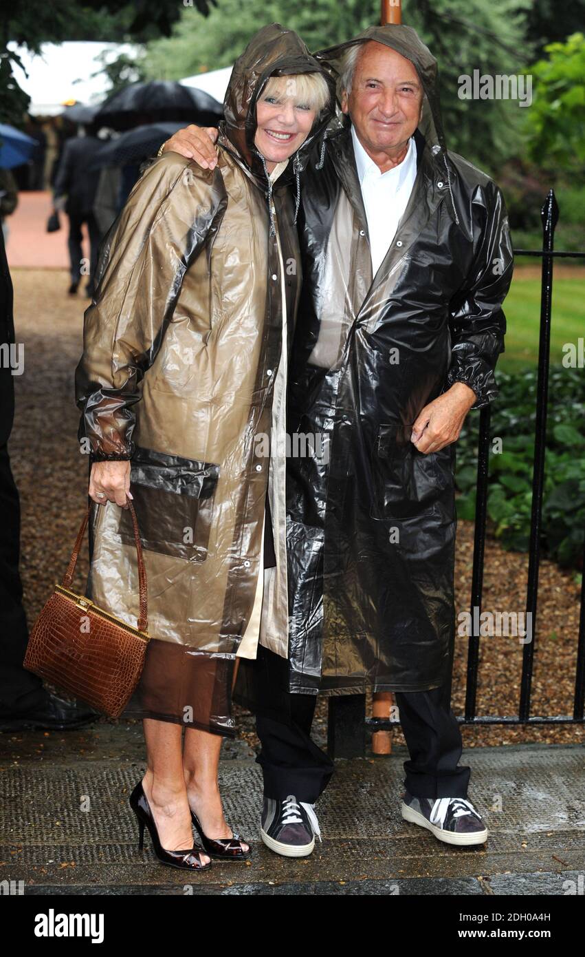 Michael Winner and partner Geraldine Lynton Edwards arrive at Sir David ...