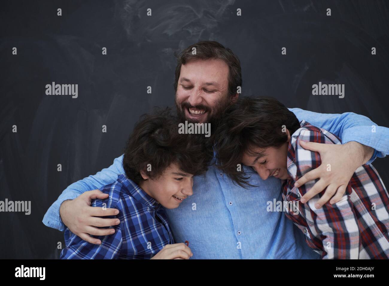 Happy father hugging sons Stock Photo - Alamy
