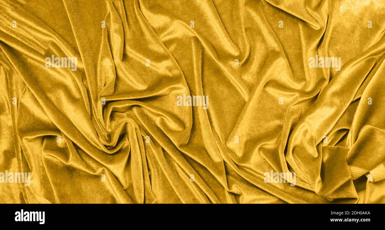 Draped velvet fabric in trendy golden yellow color. Abstract modern ...