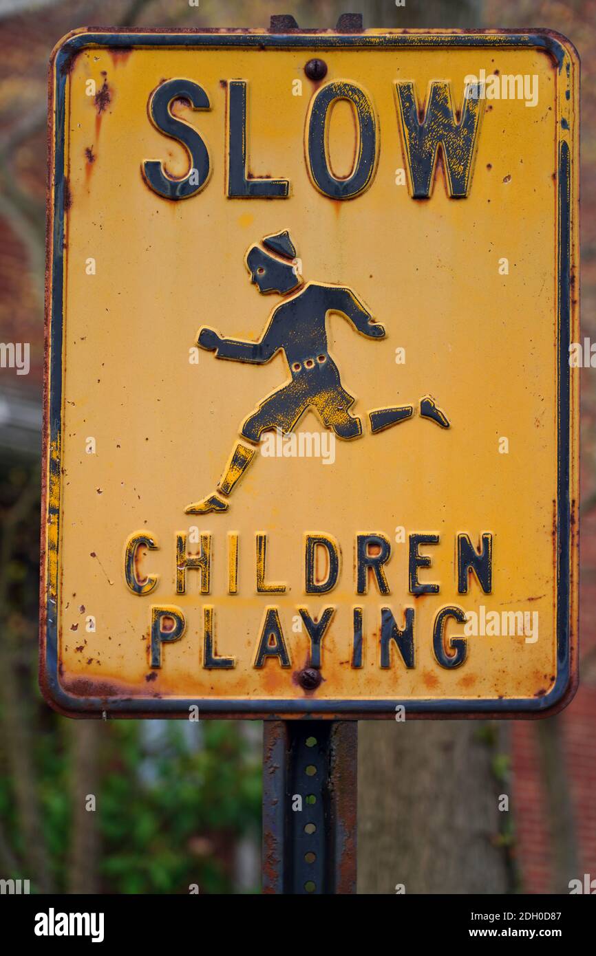 Old yellow sign saying Slow Children Playing Stock Photo - Alamy