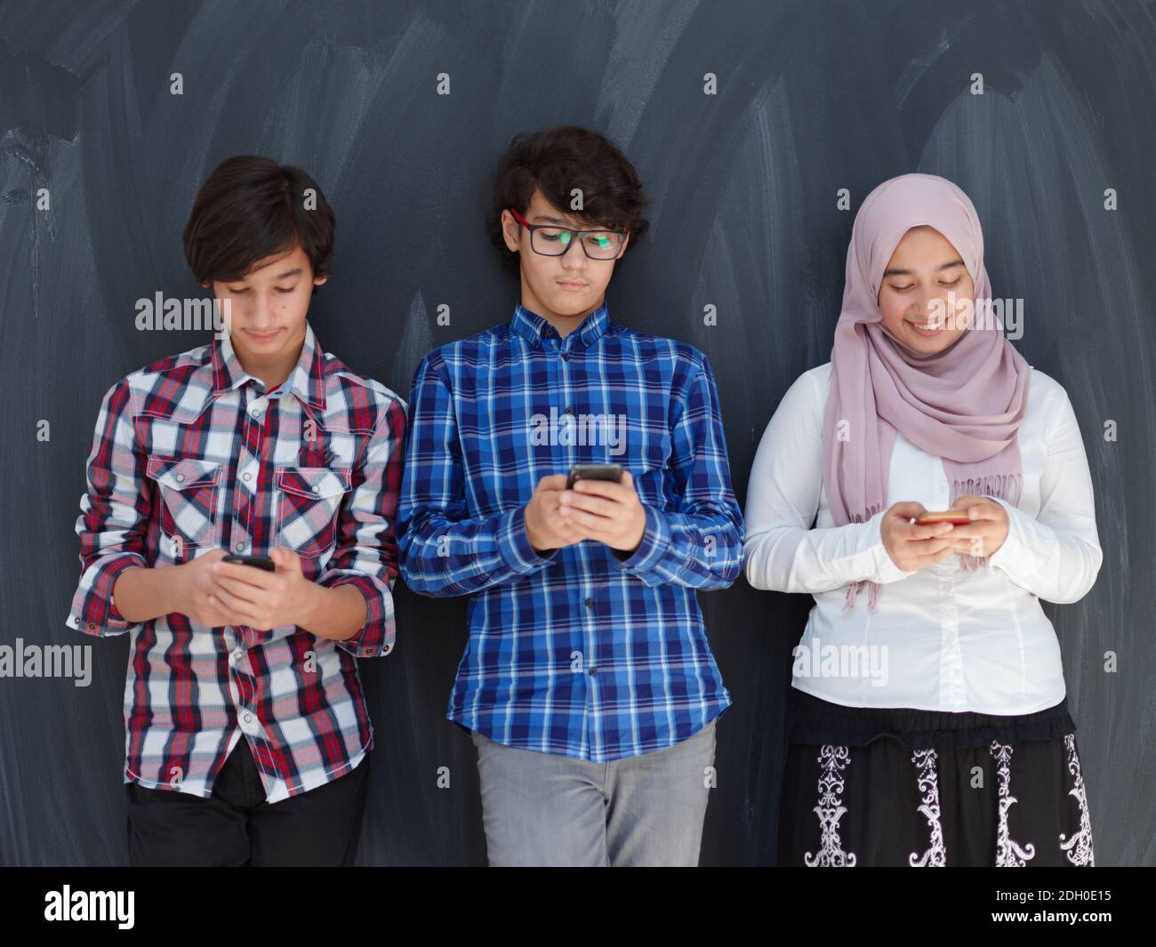 Arab teenagers group using smart phones for social media networking ...