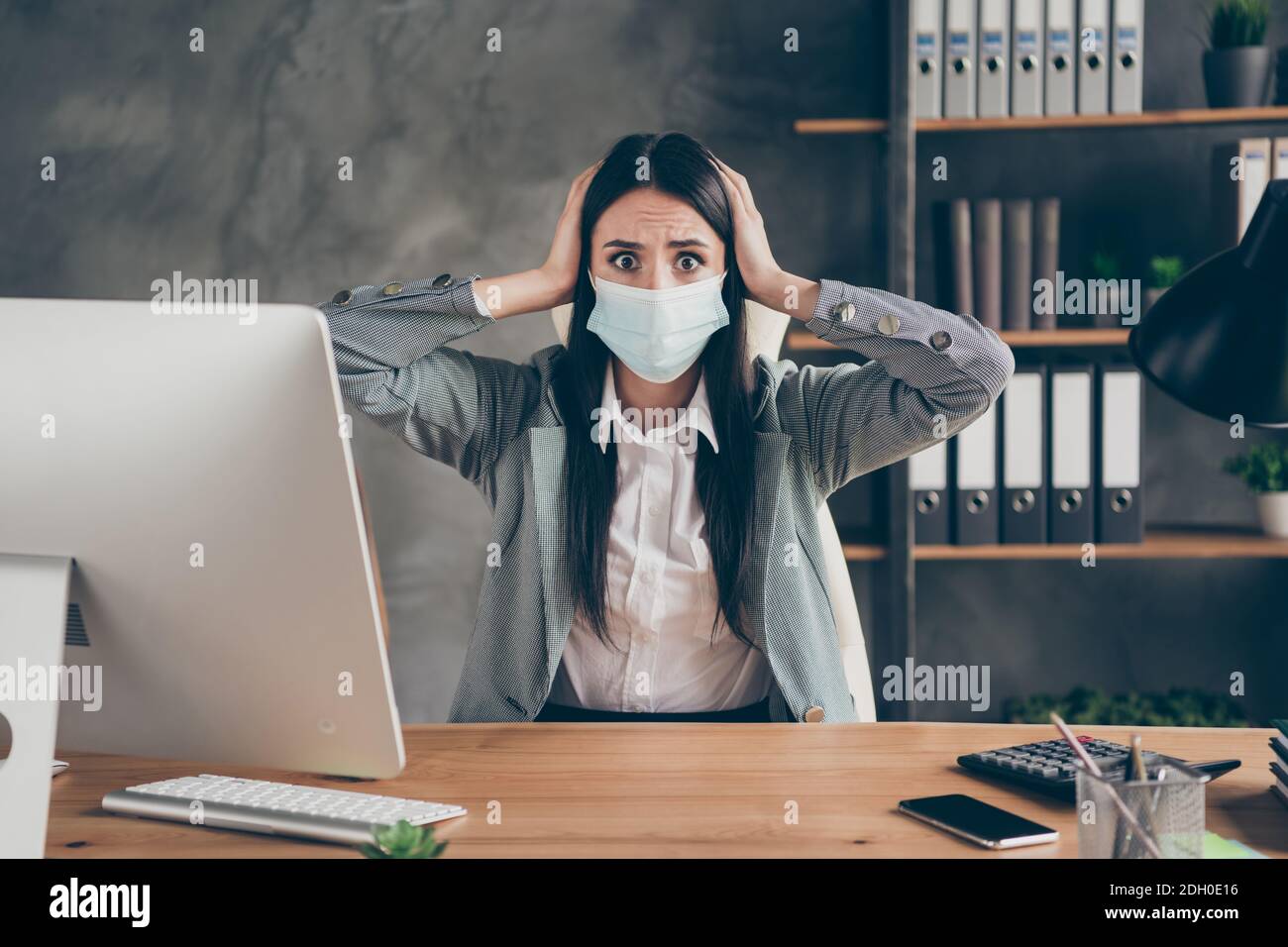 Photo of shocked worried girl medical mask agent representative sit ...