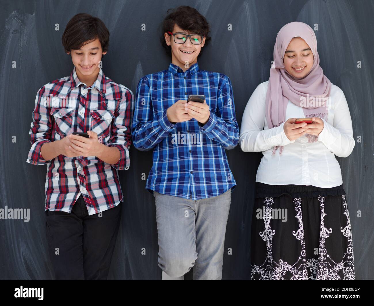 Arab teenagers group using smart phones for social media networking ...