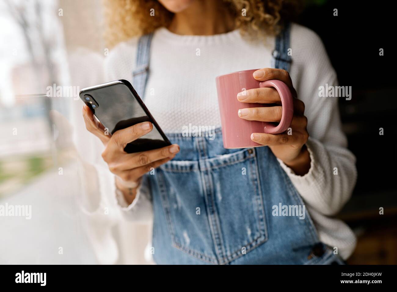 Stock photo of a middle aged woman texting with her smartphone in a ...