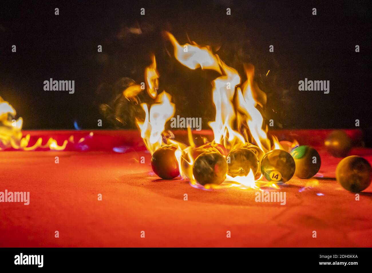 Pool Balls Are Lit On Fire While Sitting On A Pool Table In An Outdoor ...