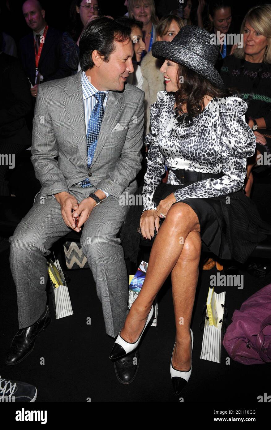 Joan Collins and Percy Gibson attending the Caroline Charles part of ...