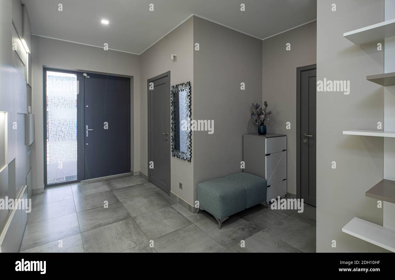 Contemporary interior of entrance hall in luxury apartment. Grey tones ...