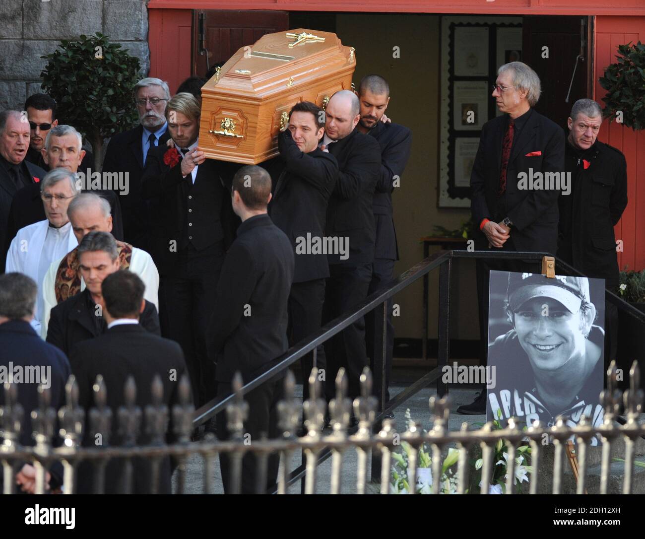 The coffin is brought out of the church by Ronan Keating, Mikey Graham ...