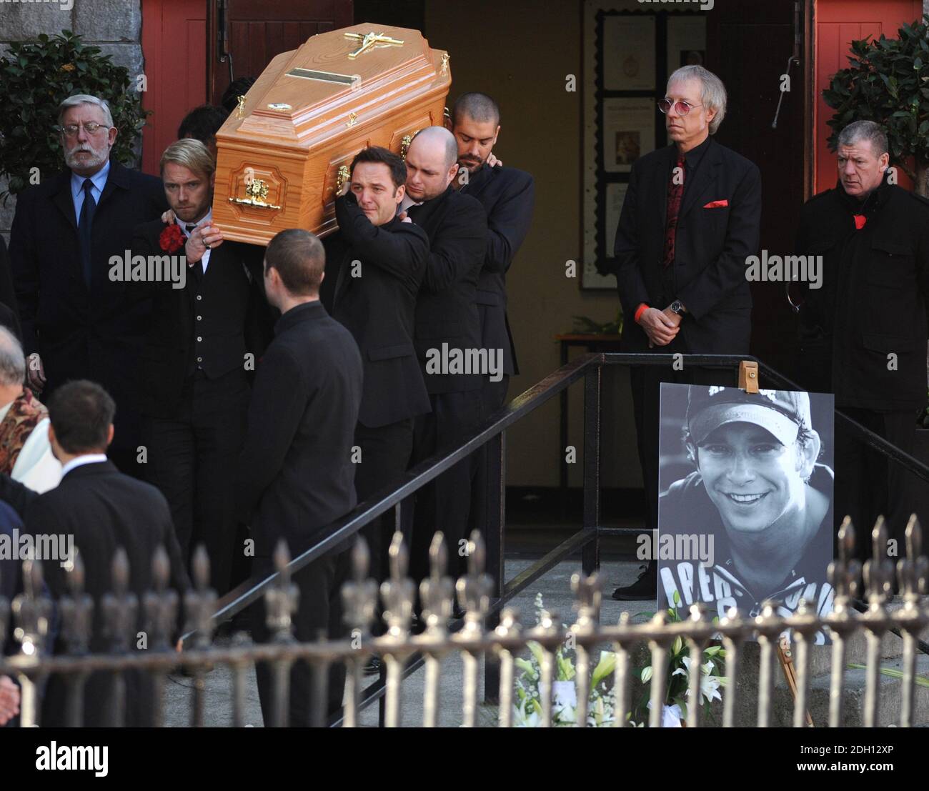 The coffin is brought out of the church by Ronan Keating, Mikey Graham ...