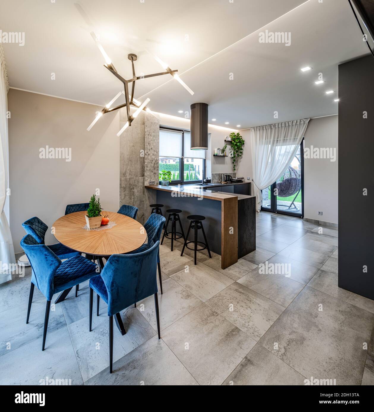 Contemporary interior of kitchen in luxury private house. Table and ...