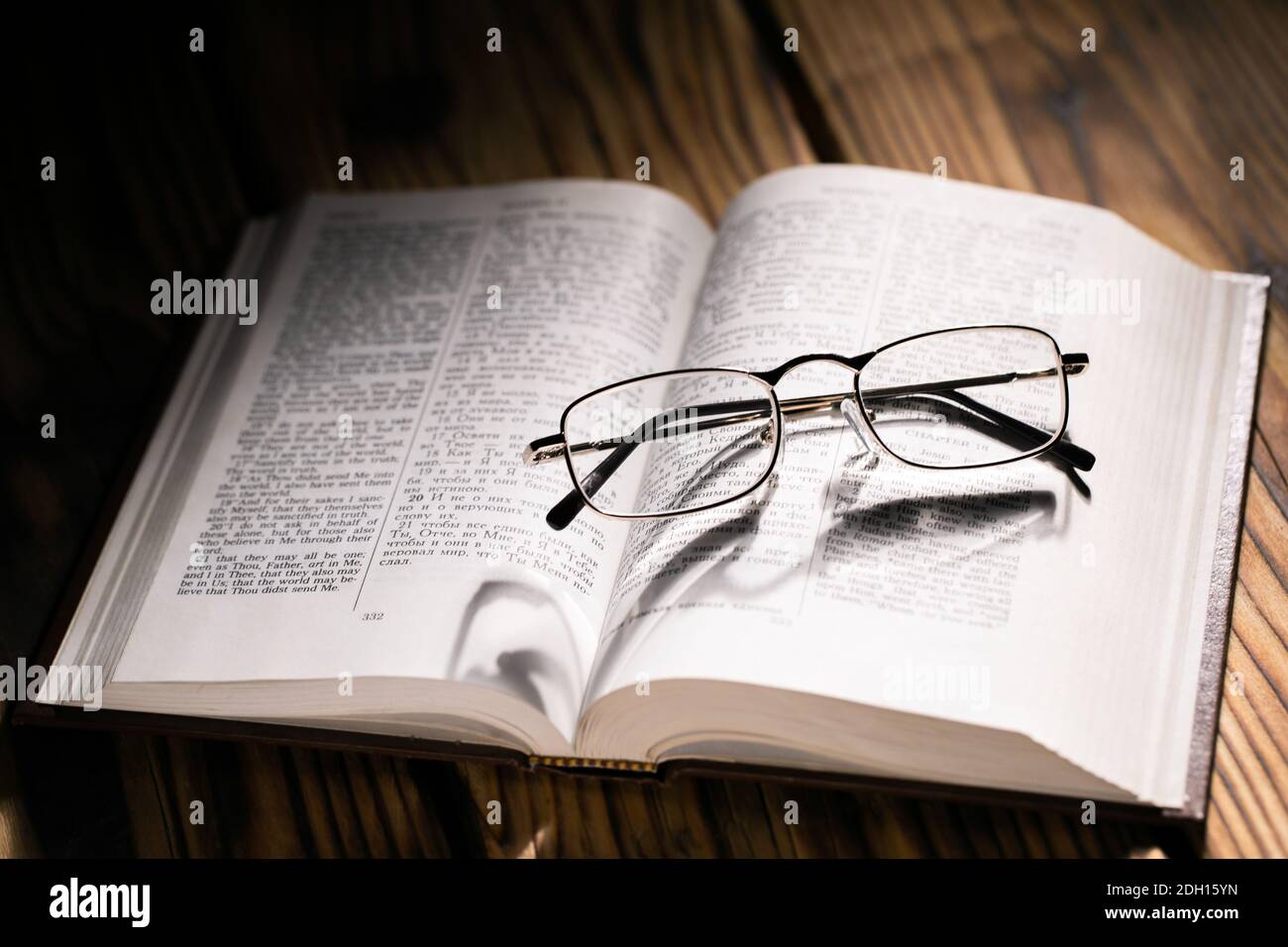 Glasses shadow on open book Stock Photo - Alamy