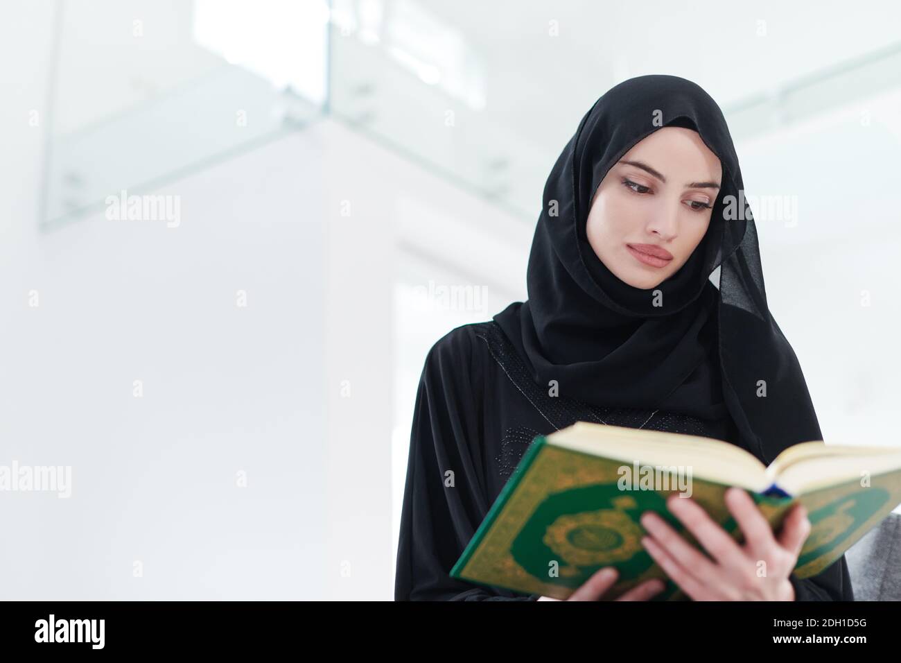 Young muslim woman reading Quran at home Stock Photo - Alamy