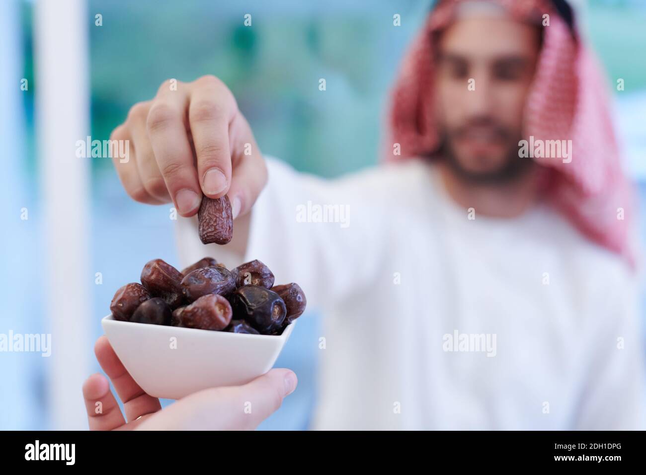 Muslim family having Iftar dinner eating dates to break feast Stock ...