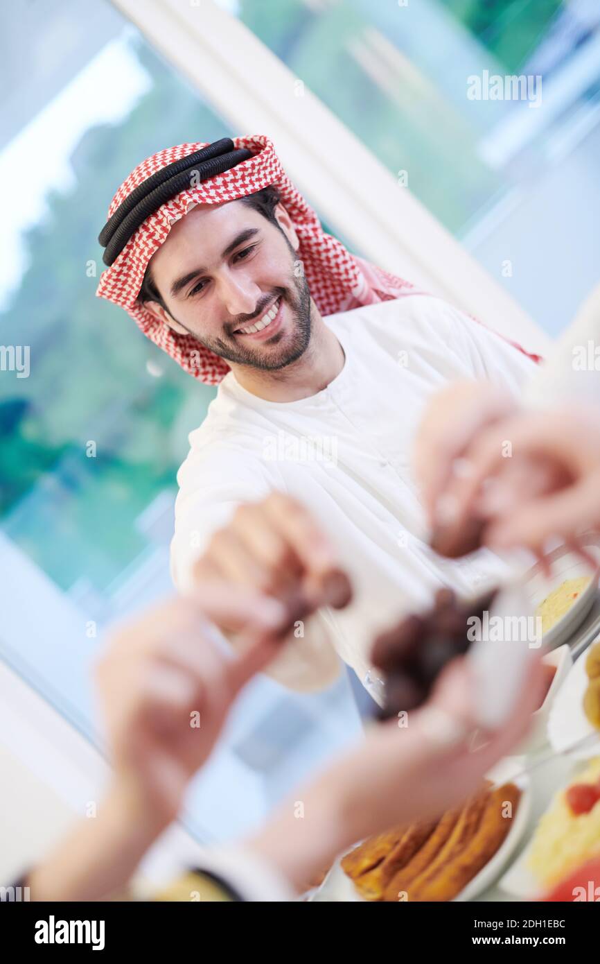 Muslim family having Iftar dinner eating dates to break feast Stock ...