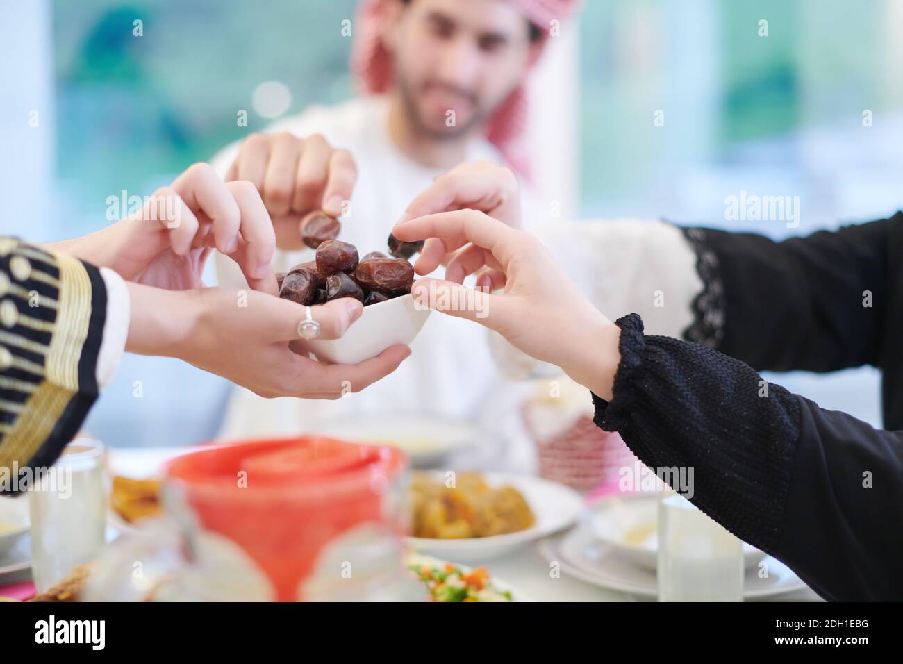 Muslim family having Iftar dinner eating dates to break feast Stock ...