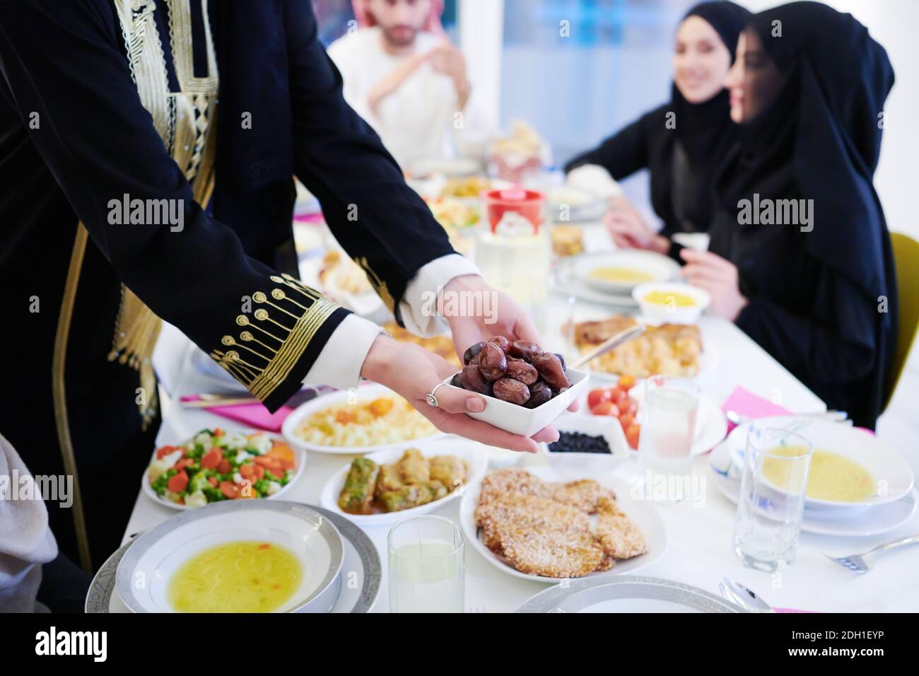 Muslim family having Iftar dinner eating dates to break feast Stock ...