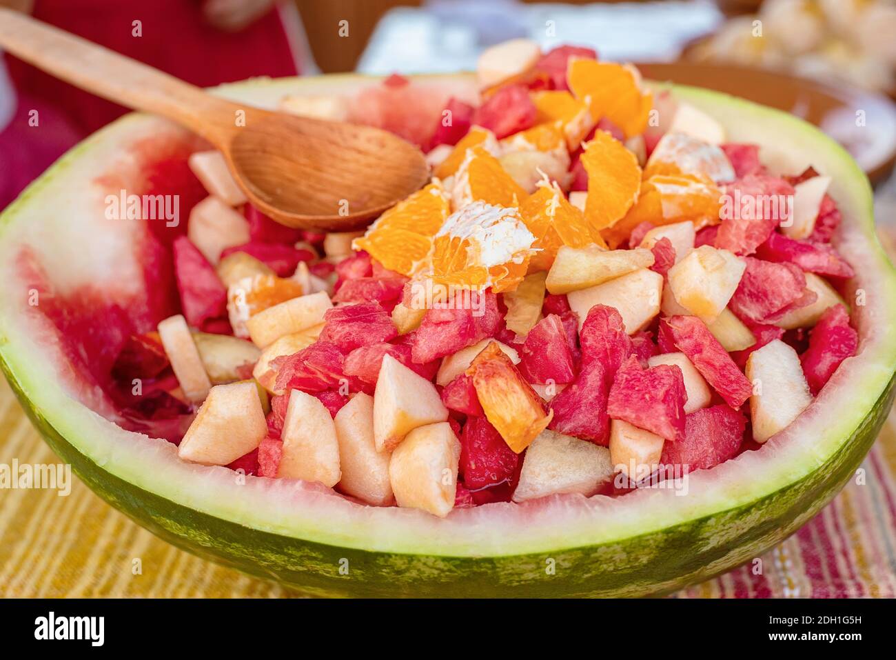 Different fruit cutted pieces in the melon Stock Photo - Alamy