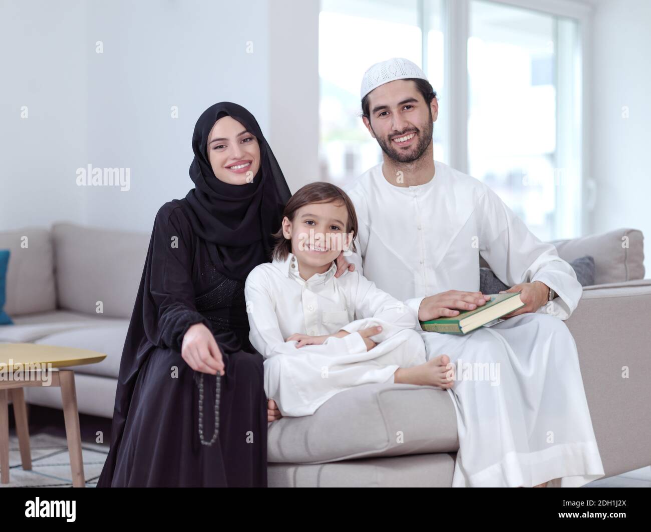 Muslim family reading Quran and praying at home Stock Photo - Alamy