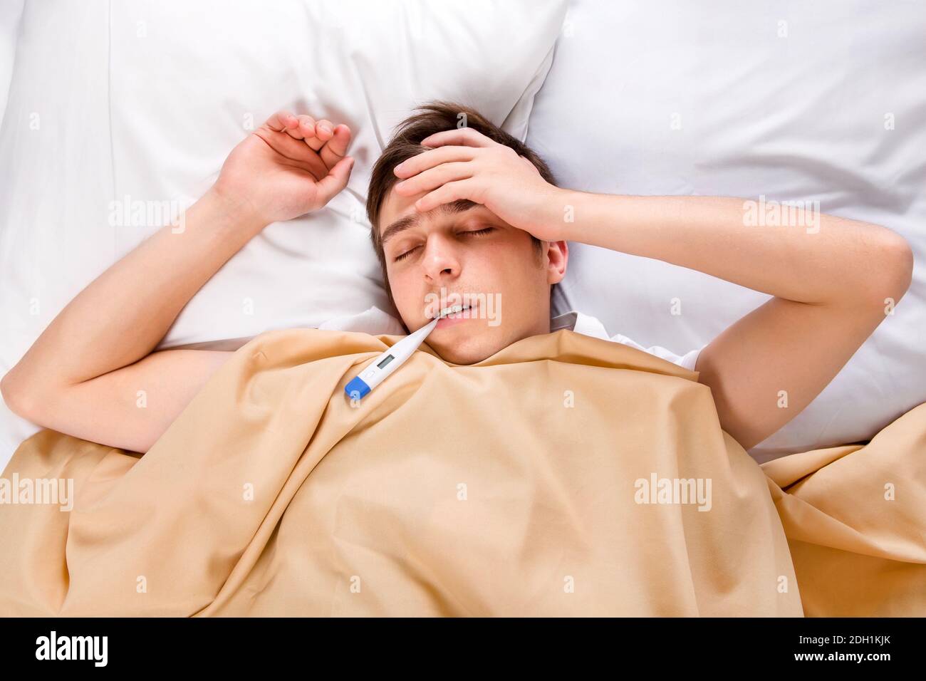 Sick Young Man sleep with a Thermometer in the Bed Stock Photo - Alamy