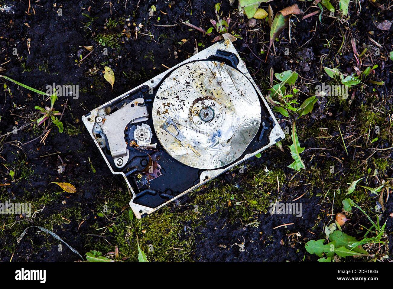 Crushed Hard Disk Drive on the Dirty Ground closeup Stock Photo - Alamy