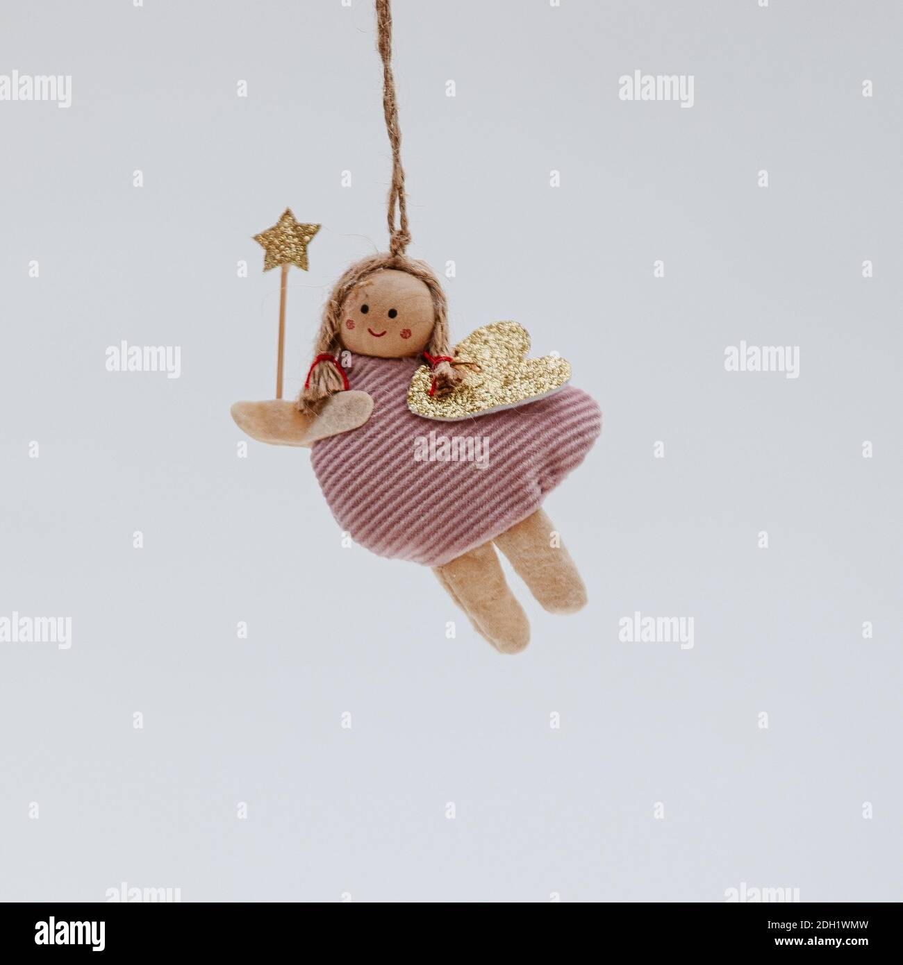 A funny soft Christmas toy in the shape of a little girl angel with a ...