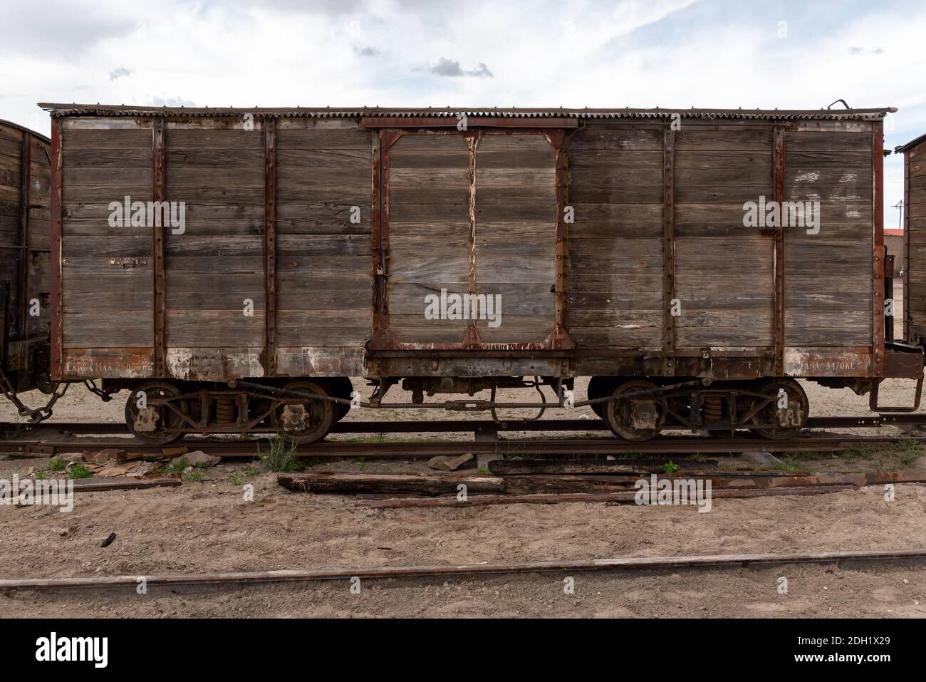 Old and rusty wooden train car abandoned on a railway track. Bolivia ...