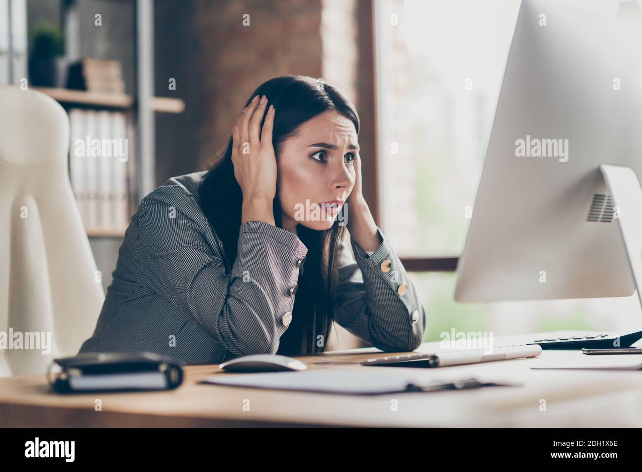 Photo of afraid scared girl work remote computer pc touch hands head ...