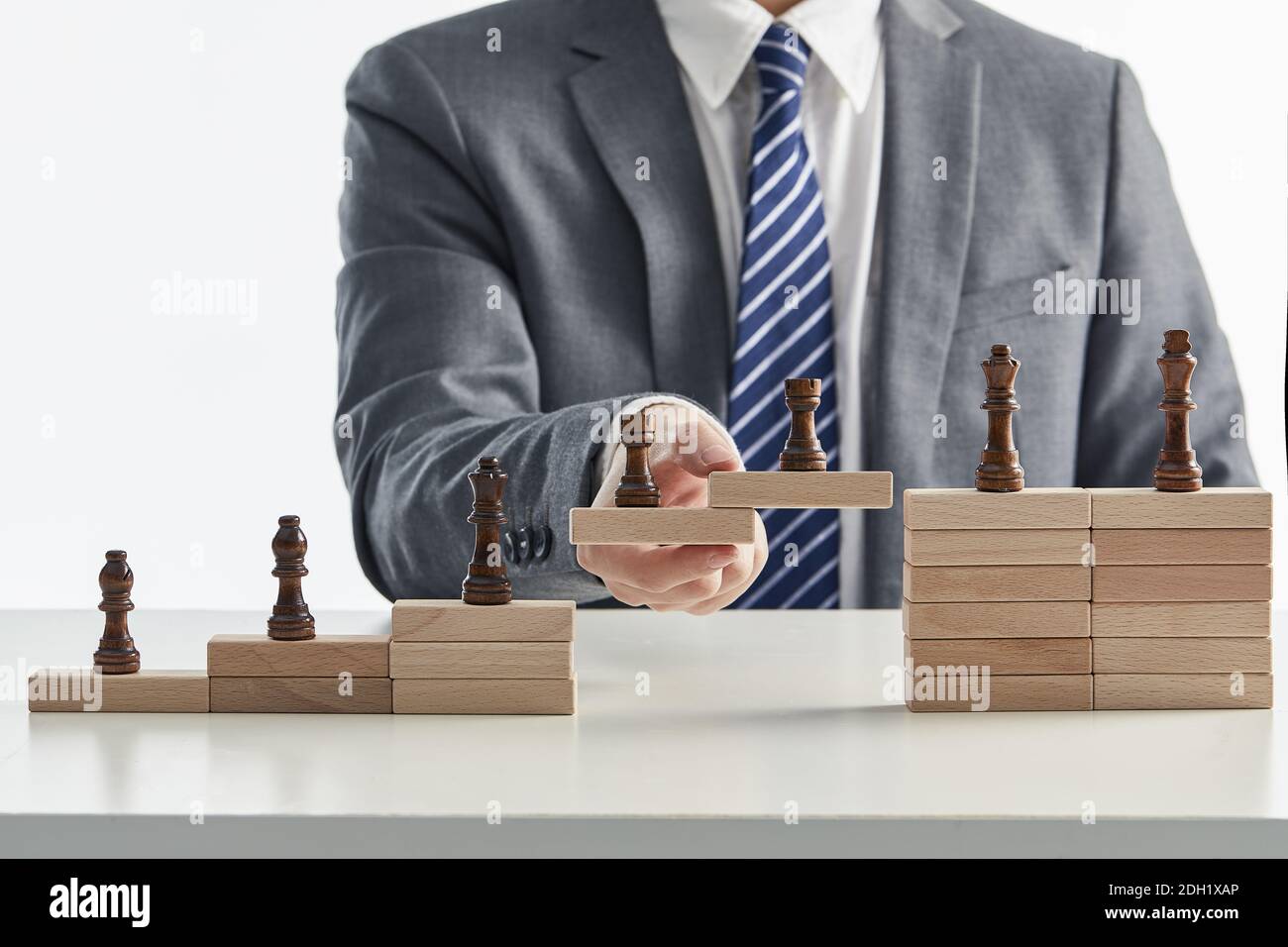 A businessman in a suit bridging the gap between corporate hierarchy ...