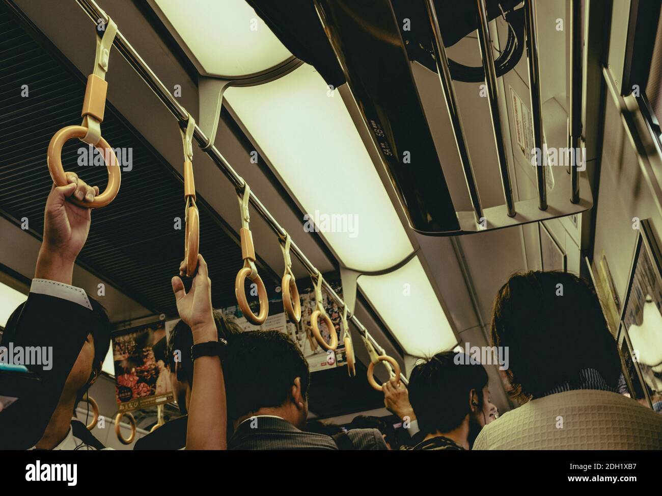 Passenger hand hold strap while standing in subway or sky train in ...