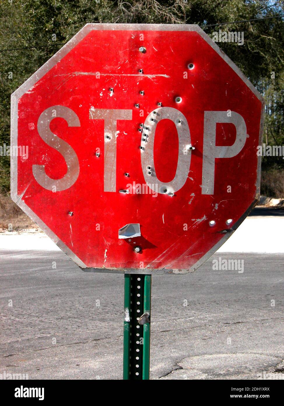 Old beat stop sign with bullet holes and other damaging marks Stock ...