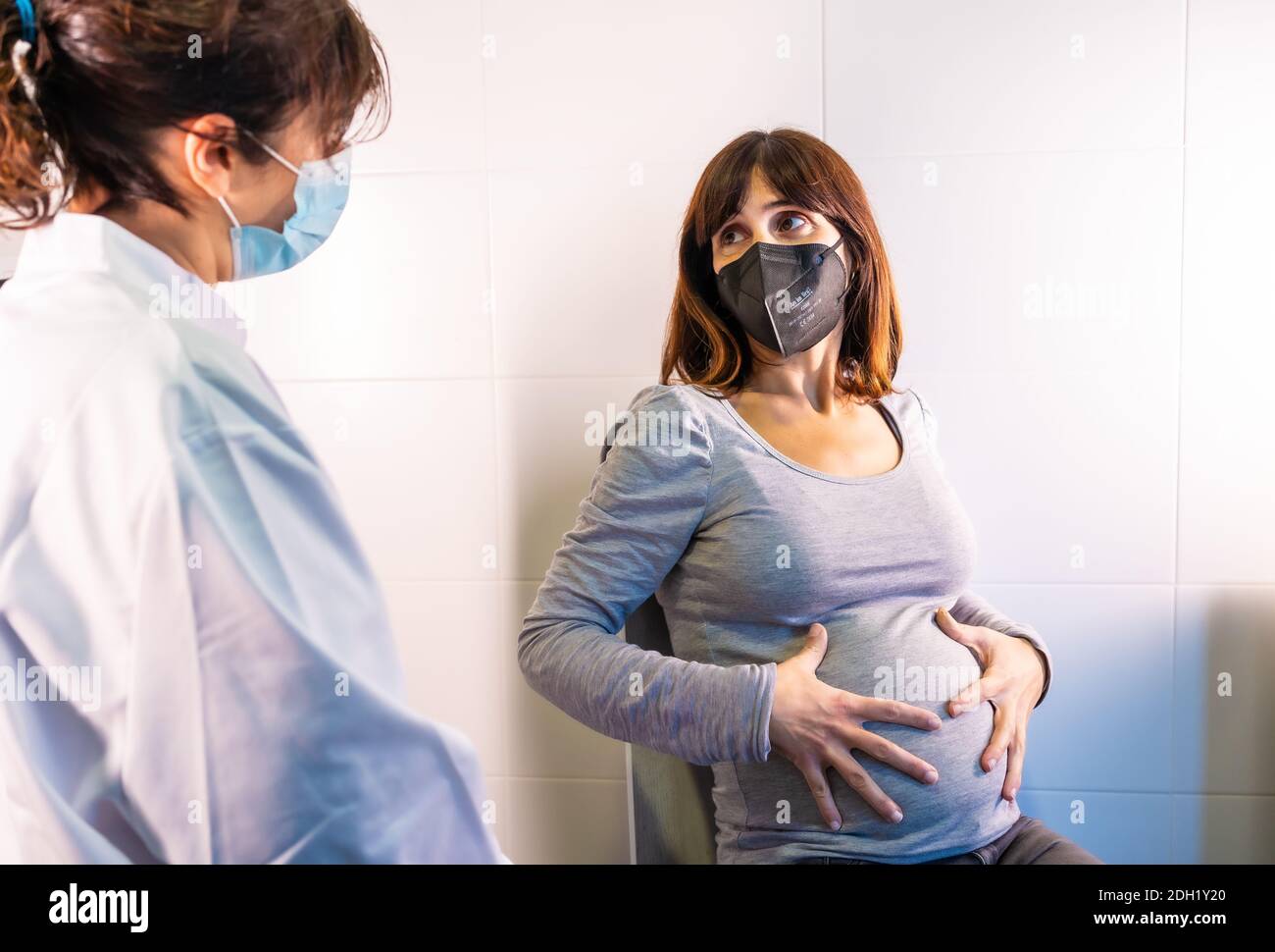 Shot of a doctor during a consultation with a pregnant patient in a ...