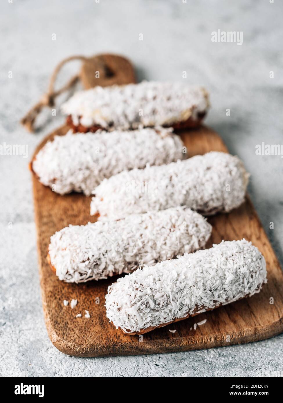 Healthy eclairs with coconut, vertical Stock Photo - Alamy